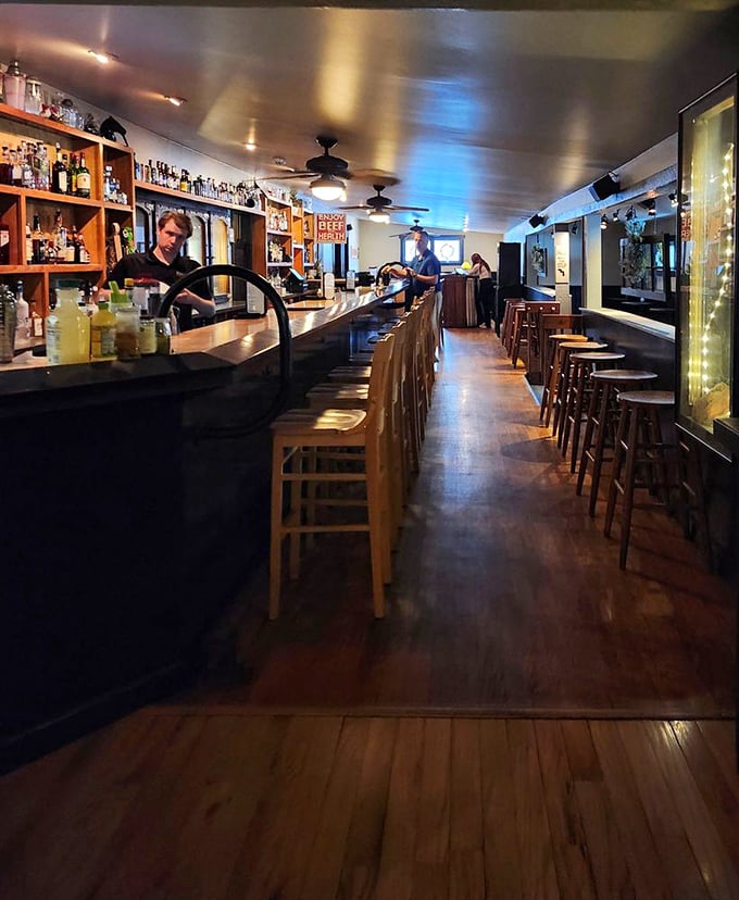 The bar stretches like a runway for spirits, with enough bottles to make even the most indecisive drinker find their perfect match.