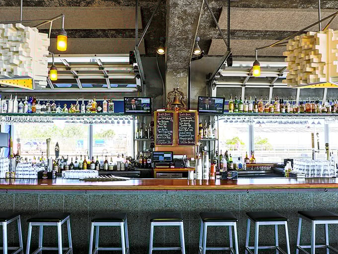 The bar at Fleet Landing isn't just serving drinks—it's serving views, with enough bottles to weather any storm that might roll in from the harbor.