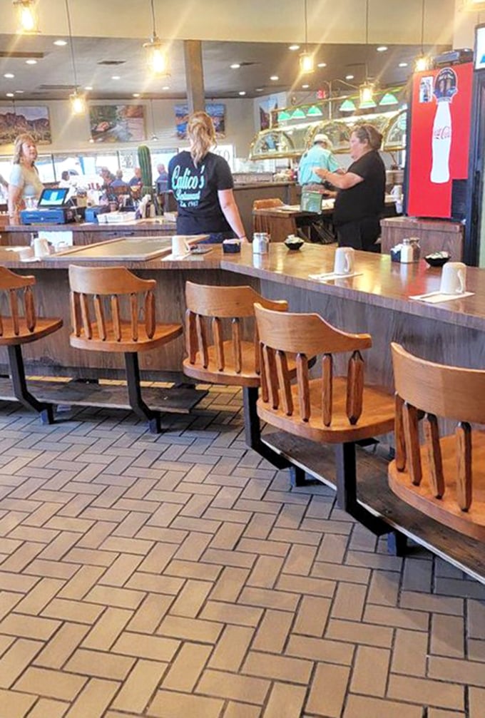 The counter where regulars become family and first-timers become regulars. Coffee flows as freely as the conversation.