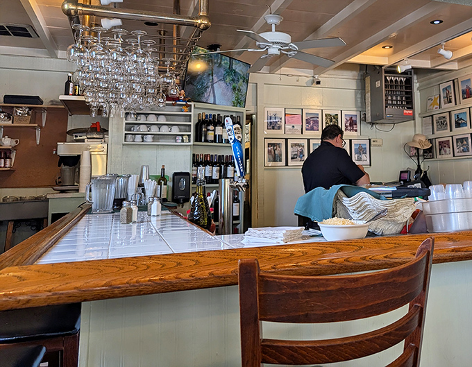 The bar area—where wine glasses hang like crystal stalactites and stories flow as freely as the California wines being poured.