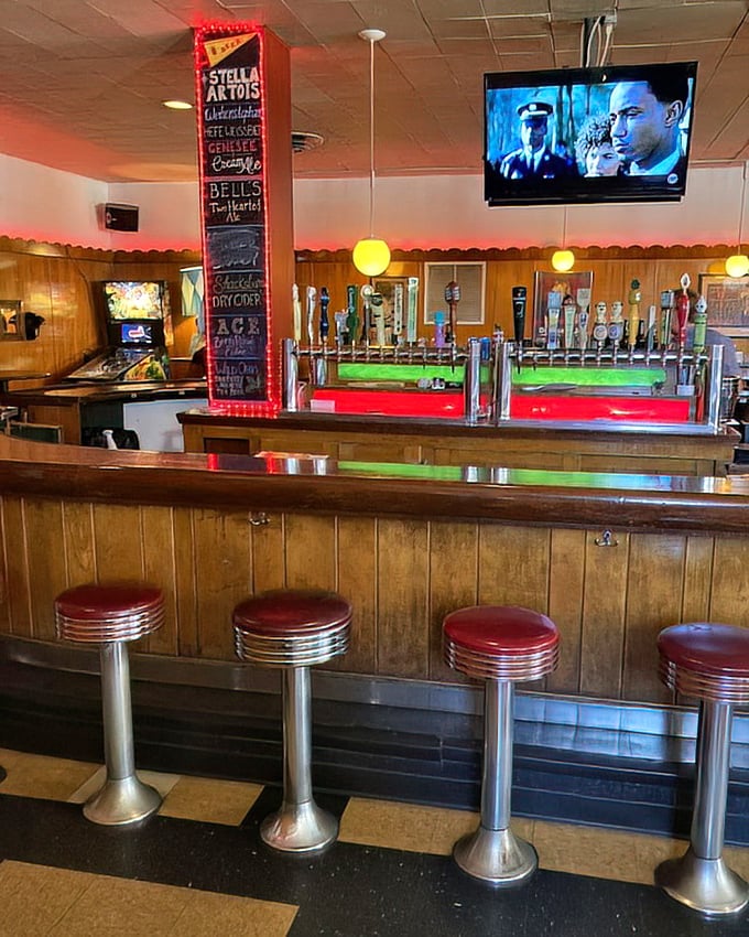 Retro vibes and modern brews. The illuminated tap handles glow like beacons, guiding you to refreshment between bites of loaded dogs.