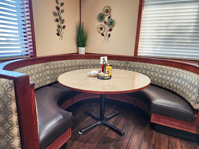 The curved booth isn't just seating—it's a semicircle of comfort that hugs you while you hug your coffee cup. Breakfast in the round.