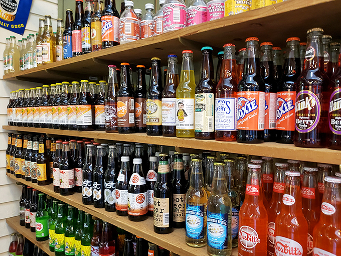 A rainbow of glass bottles promising fizzy nostalgia—sodas from another era when "pop" meant something you drank, not heard.
