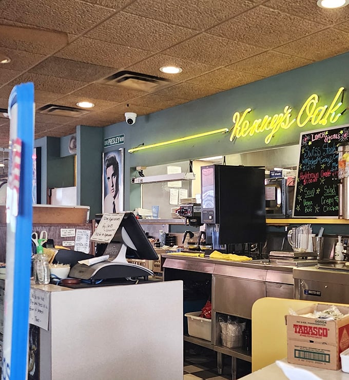 The neon Kenny's Oak Grill sign glows above the order counter, where friendly service meets serious home-style cooking.