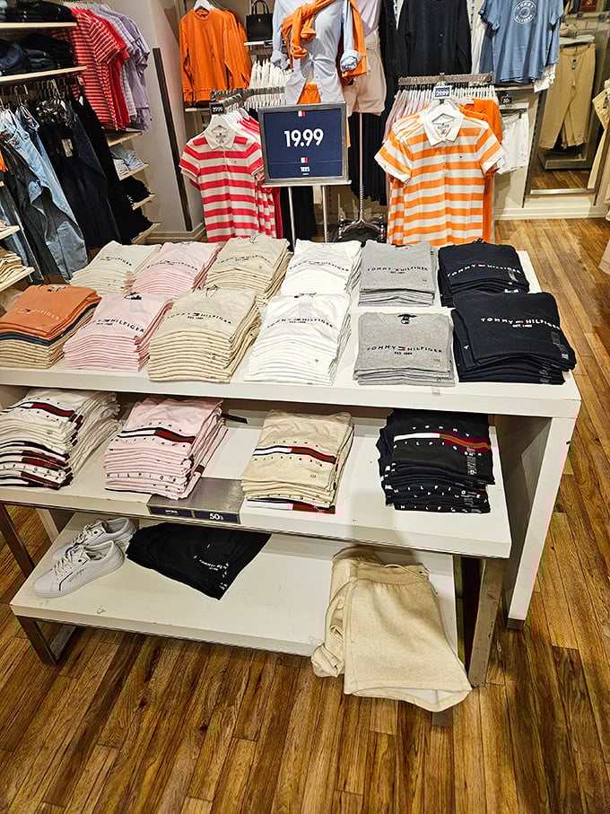 Tommy Hilfiger's display showcases the brand's signature preppy aesthetic—where nautical stripes and bold colors promise to upgrade your wardrobe without downgrading your bank account.