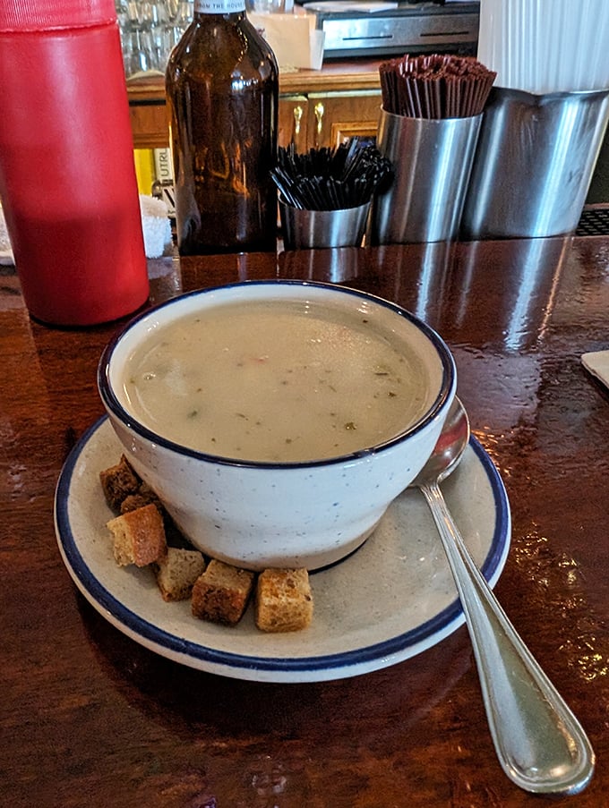 A bowl of clam chowder surrounded by house-made croutons—the kind of soup that makes you wish winter lasted just a little longer.