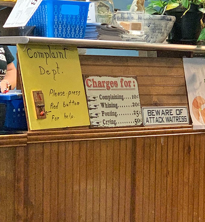 The complaint department sign that tells you everything about this place's sense of humor.