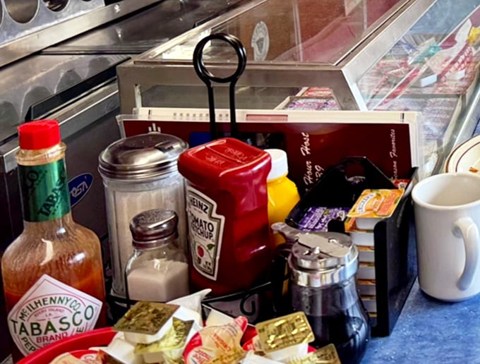 The condiment caddy—a miniature neighborhood of flavor enhancers—stands ready to customize your meal exactly the way you've liked it since childhood.
