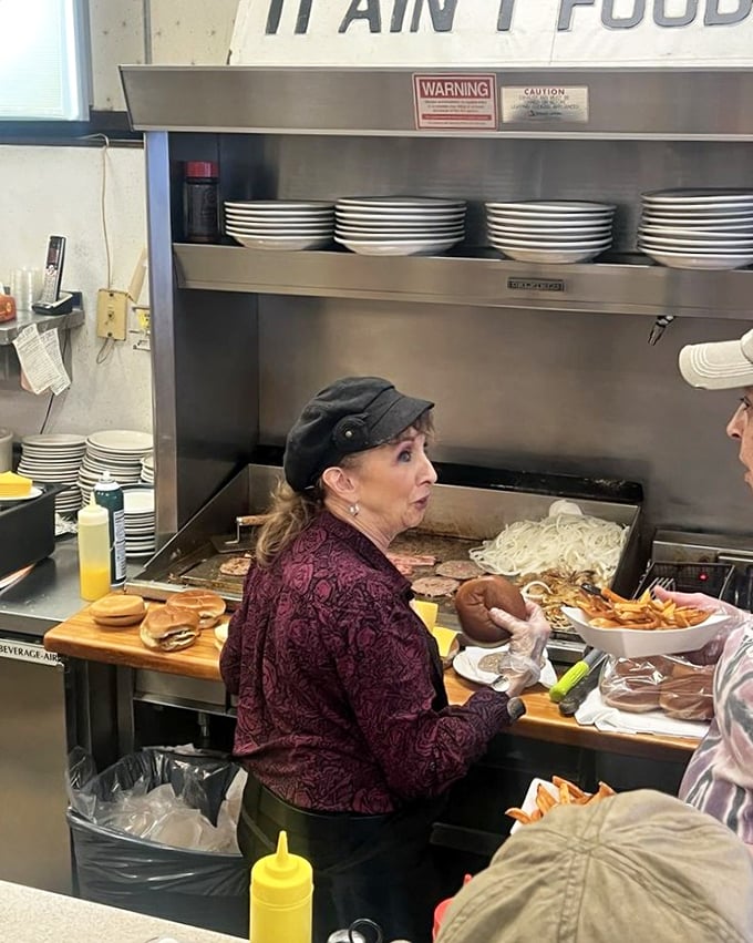 Where the magic happens—skilled hands crafting comfort food classics on a grill that's seen more action than an Indiana Jones movie.