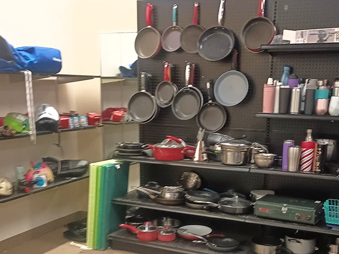 Cookware hanging like modern art—proof that Julia Child's spirit lives on in these previously-loved pots and pans.