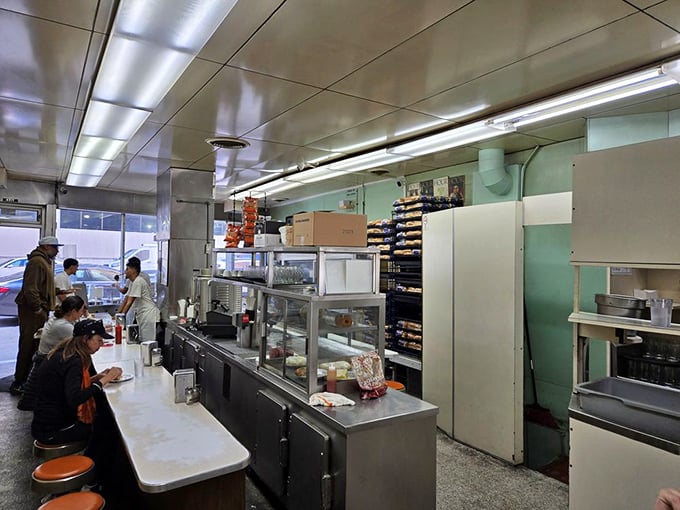 Where the magic happens. The counter view offers front-row seats to the culinary choreography that's been perfected over decades.