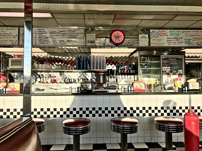 The counter where magic happens – gleaming chrome, spinning stools, and the promise of friendly conversation that's been the heart of American diners since the Eisenhower administration.