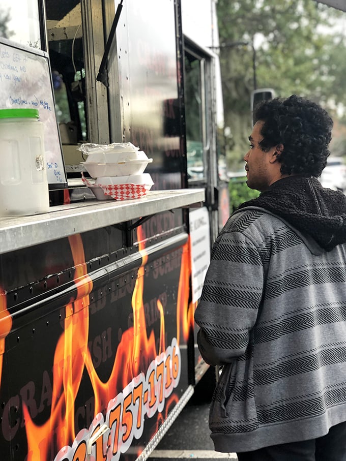 The moment of truth—when anticipation meets reality at the pickup window. This is where seafood dreams are packaged in humble containers. 