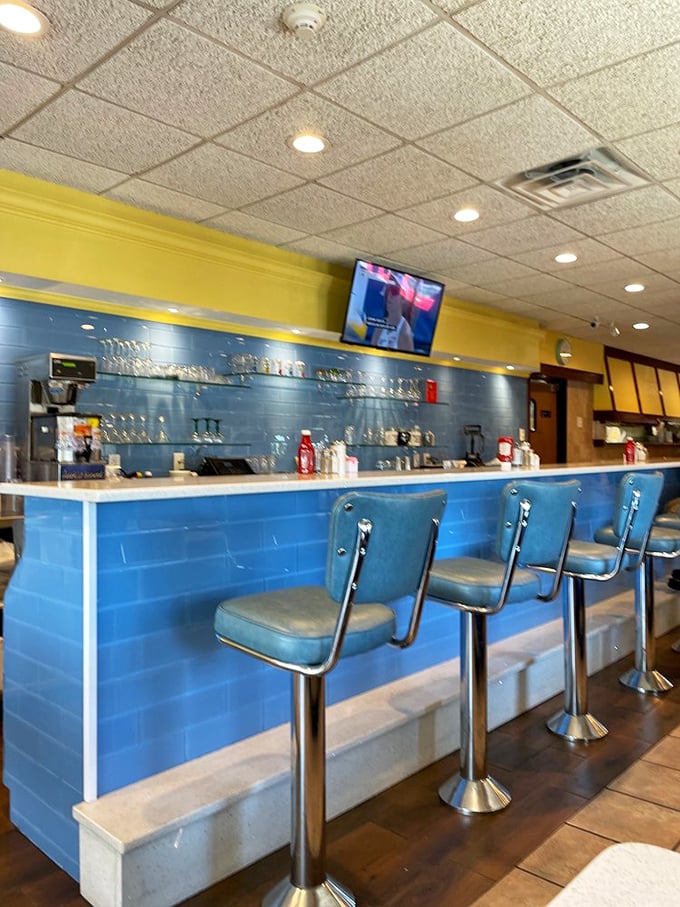 The blue-tiled counter with retro stools isn't just seating—it's a time machine to when diners were the original social networks.