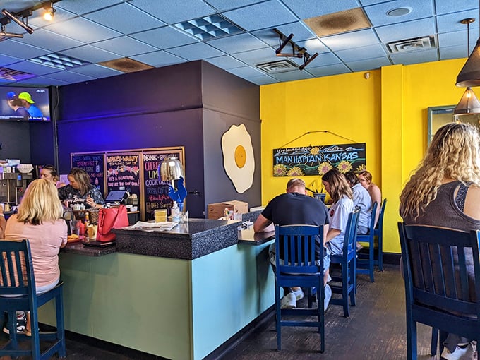 Counter seating where regulars solve world problems over scrambled eggs and endless coffee refills.