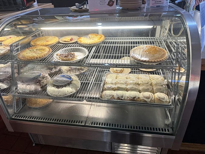 The dessert case—where willpower goes to die. Those pies aren't just baked; they're crafted with the kind of love that makes calories irrelevant.