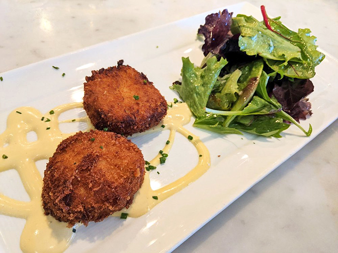 These crab cakes have achieved the impossible—crispy exterior giving way to sweet, flaky crab meat with minimal interference.