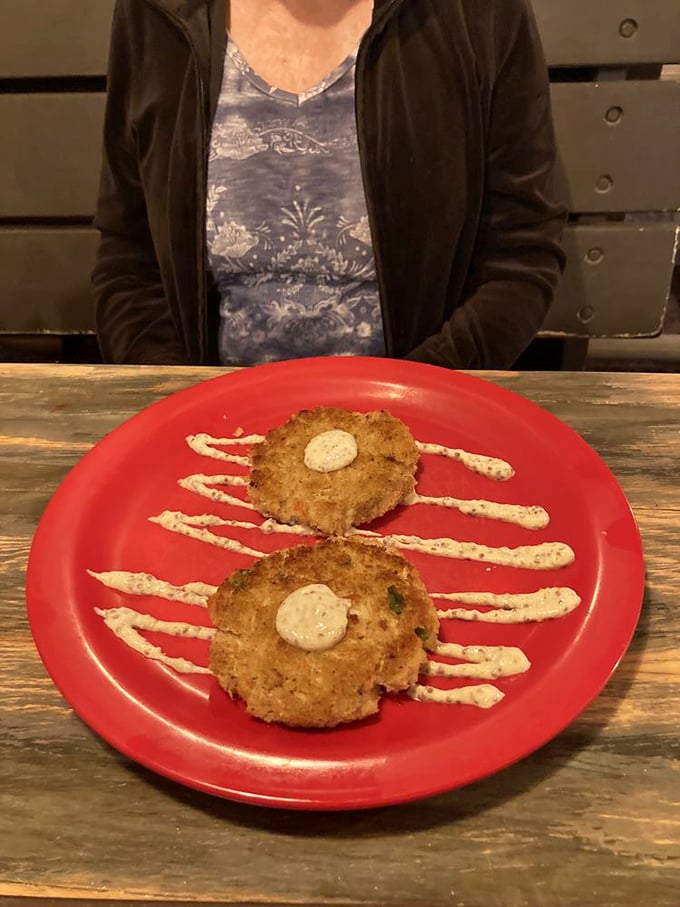 Crab cakes with artistic sauce drizzles—seafood transformed into comfort food that would make Maryland jealous of Florida's crab game.