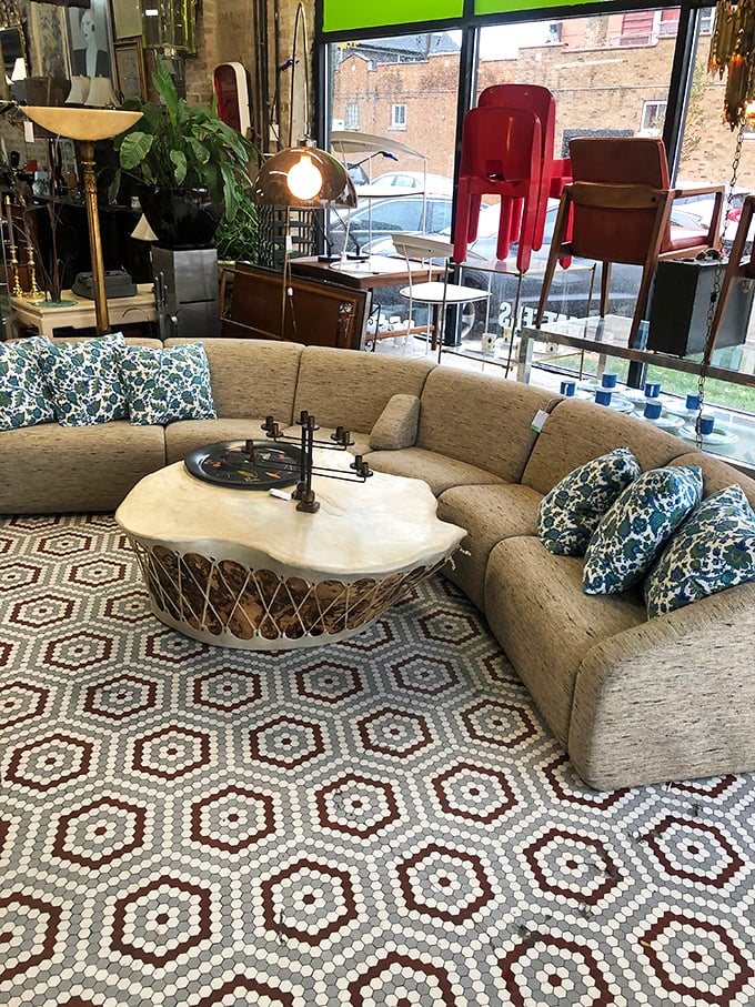 A curvy sectional sofa embraces a marble-topped coffee table, creating the perfect setting for your next gathering of witty friends.