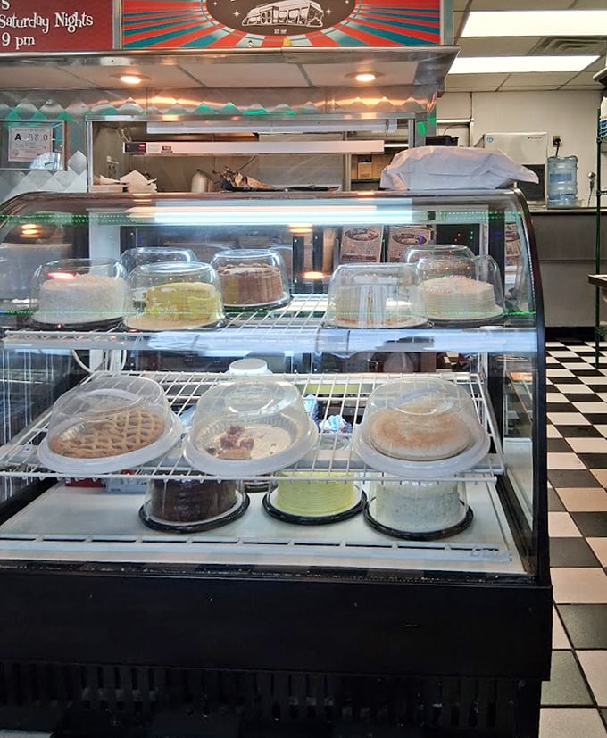 The dessert case—a glass-enclosed museum of temptation where willpower goes to die a delicious death.