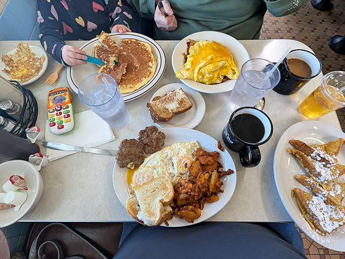 A table full of breakfast bounty—pancakes, eggs, home fries, and toast creating a morning feast that puts cereal to shame.