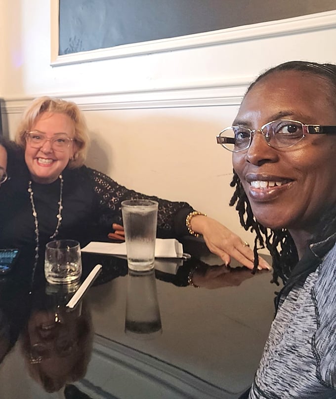 Happy diners sharing stories and sips—the universal language of "this food was worth getting out of bed for."