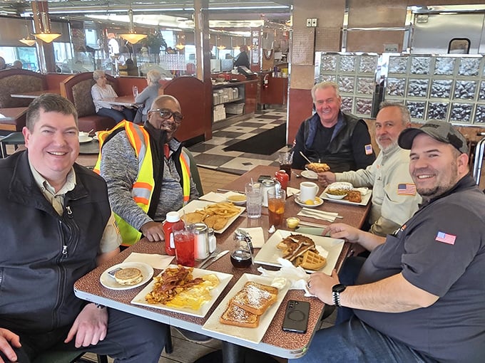 A gathering of friends proving that the best business meetings happen over plates of pancakes and endless coffee refills.