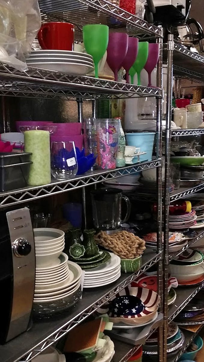 Colorful glassware and pristine white plates stacked with precision—proof that someone else's kitchen cleanout becomes your entertaining upgrade.