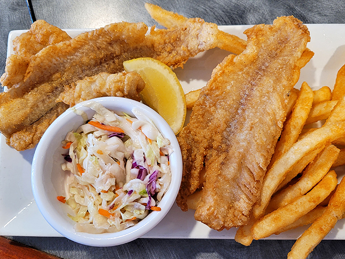 Lake Erie walleye fried to golden perfection with crispy fries and fresh coleslaw—a Great Lakes trifecta that never disappoints.