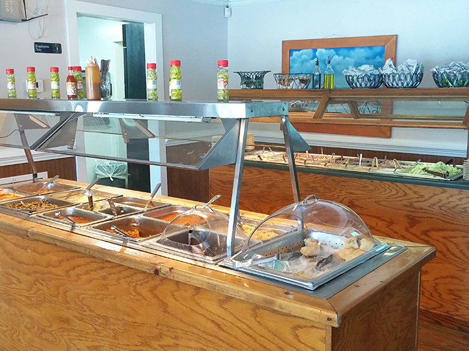 The buffet line – where decisions get tough and pants get tighter. Each steam tray holds a different Southern specialty waiting to comfort you.