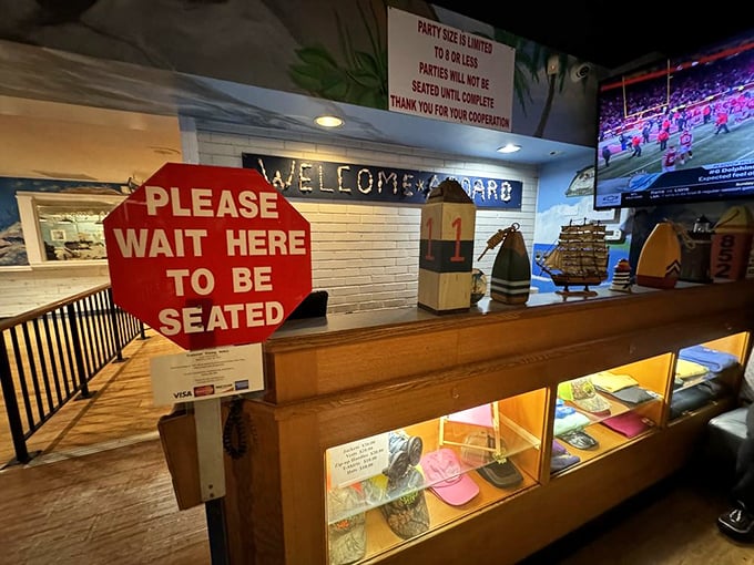 The entrance area—where anticipation builds and hunger deepens. That "Please Wait" sign might as well say "Prepare for Deliciousness Ahead."