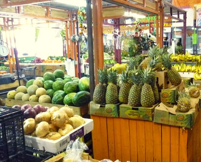 The tropical fruit section—where pineapples stand at attention and watermelons lounge casually, waiting to become your next poolside companion.