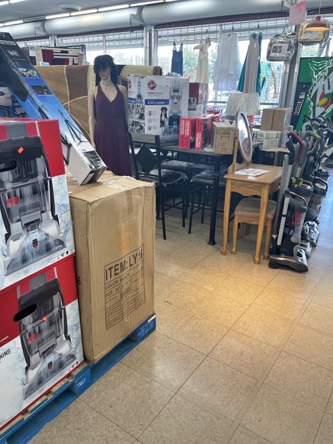 Furniture finds and mannequins stand guard over boxed appliances – the thrifter's version of an IKEA showroom.