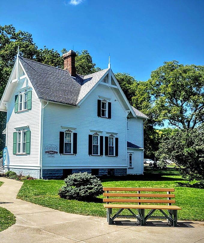 The keeper's house—where lighthouse history comes alive inside this picture-perfect white cottage with its welcoming green shutters.