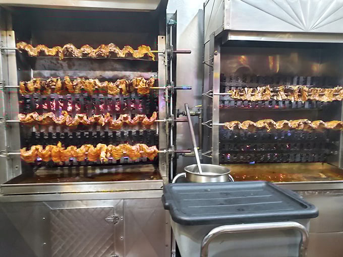 The rotisserie in action—where chickens perform their hypnotic carousel dance before becoming the star of someone's dinner plate. Mesmerizing and mouth-watering simultaneously.