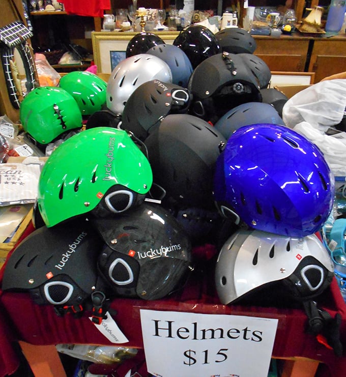 "Helmets $15" reads the sign above a colorful pile of protective headgear—because even your safety equipment can make a style statement.