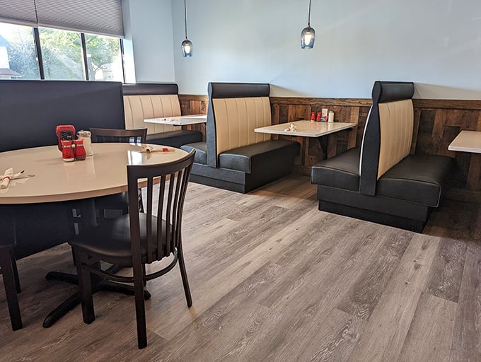 Booths that invite you to stay awhile. The clever mix of cream and black seating against wood paneling creates an atmosphere of casual sophistication.