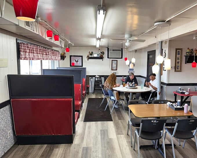 Simple tables, comfortable seating, and red accents create the perfect backdrop for the main attraction—food that makes you forget to check your phone.