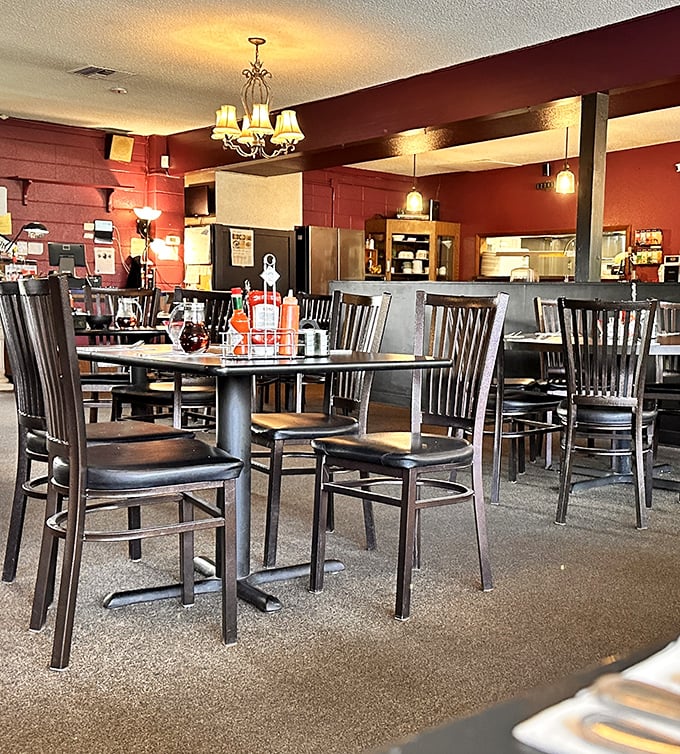 Warm lighting from chandeliers creates the perfect ambiance for both first dates and regular Tuesday breakfasts. Cozy without trying too hard.