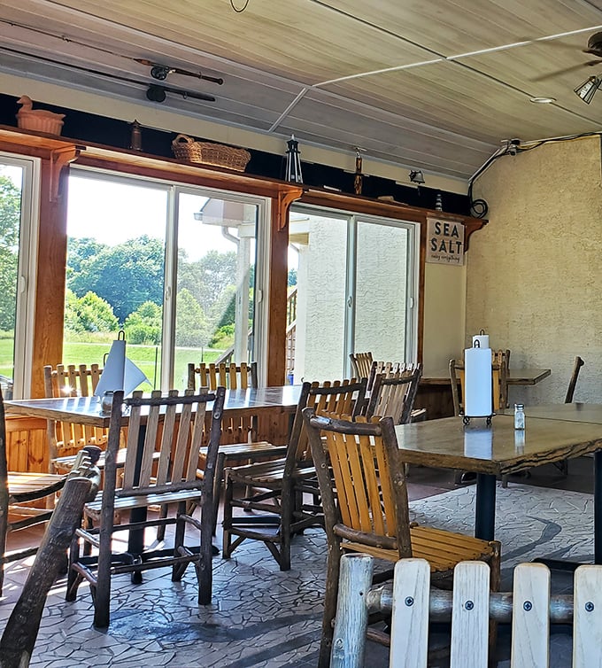 Rustic wooden chairs and large windows create a dining space where the outside world complements the seafood experience perfectly.