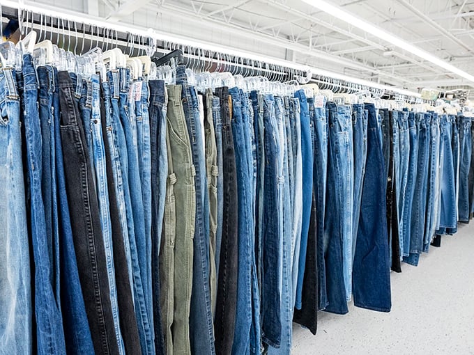 The denim wall – a blue jean rainbow where someone else's "these don't fit anymore" becomes your perfect pair.