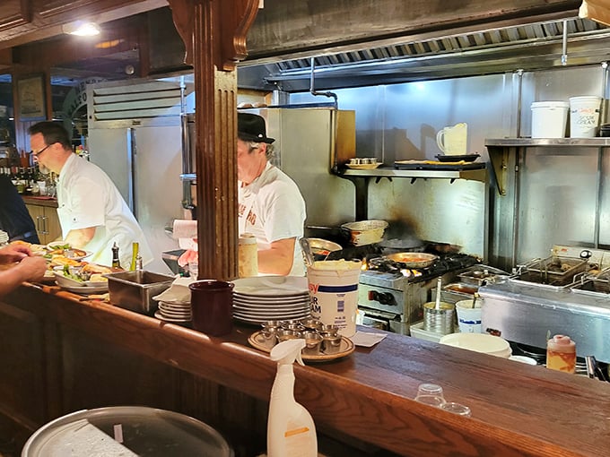 The kitchen's choreographed chaos reveals the alchemy behind Henry's legendary seafood – where fresh ingredients meet culinary expertise.