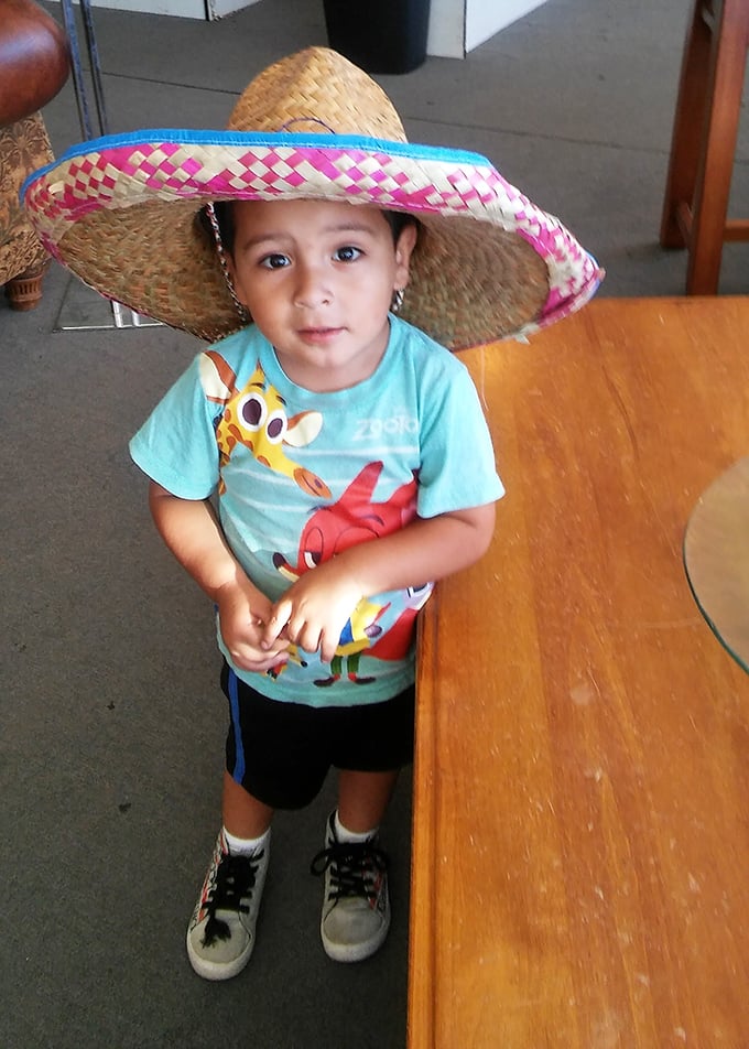 Young treasure hunters start early! This little explorer models a sombrero find that's clearly too good to leave behind.