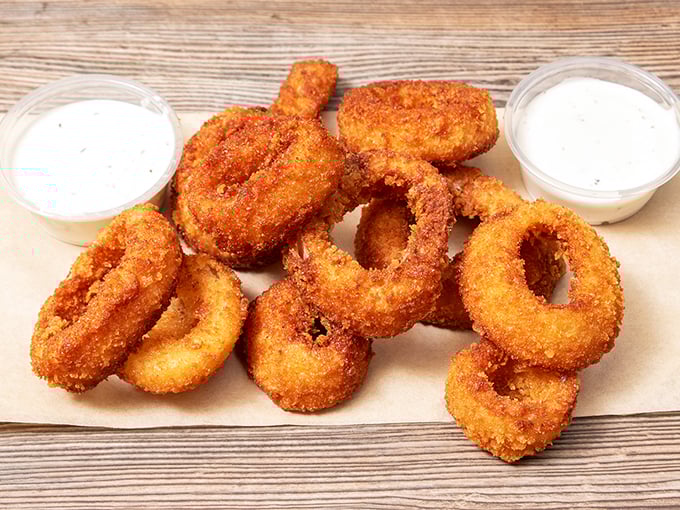 Golden-brown onion rings with a satisfying crunch that announces itself to everyone within earshot—worth every calorie.