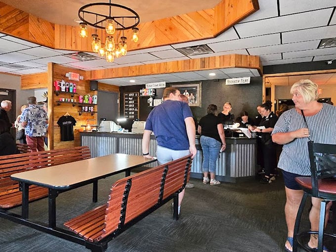 Where supper club magic happens—wooden booths, warm lighting, and the promise of a meal that will require loosening your belt afterward.