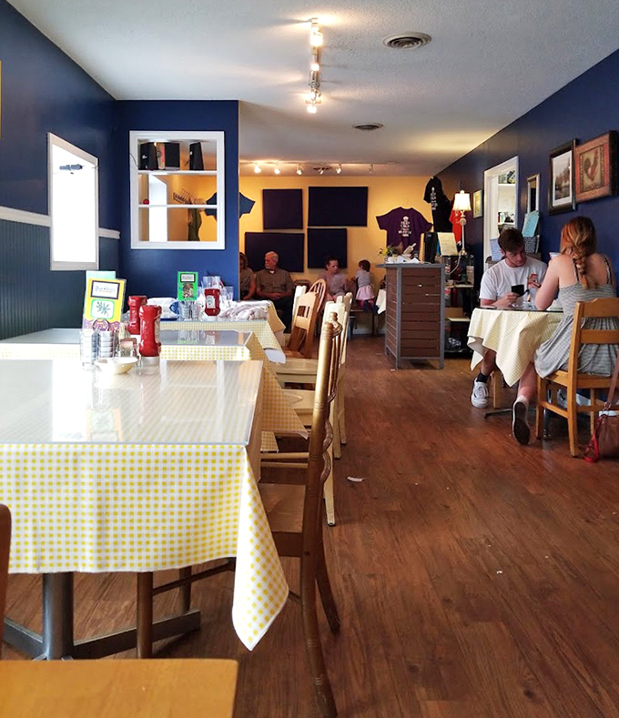 Blue walls, yellow accents, and checkered tablecloths—a color scheme that says "good morning" before the coffee even arrives.
