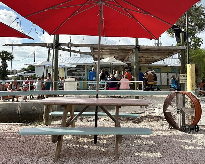 Red umbrellas provide shade while you contemplate life's big questions, like "How soon is too soon to come back tomorrow?"