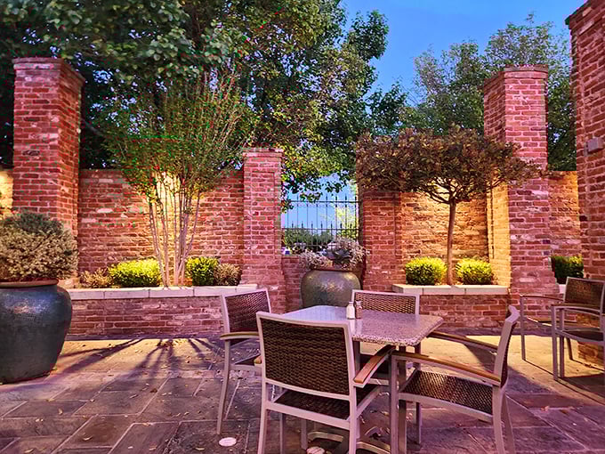 The outdoor patio offers a serene escape where brick walls and potted plants frame conversations and cocktails under New Mexico skies.