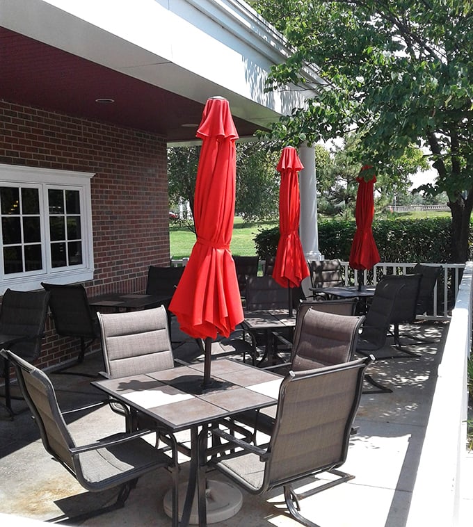 The patio offers al fresco feasting under cheerful red umbrellas—because barbecue this good deserves fresh air and sunshine between bites.