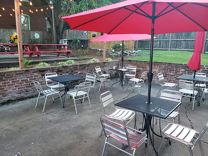 The outdoor patio—where fresh air and smashburgers come together in a beautiful al fresco romance under cheerful red umbrellas.